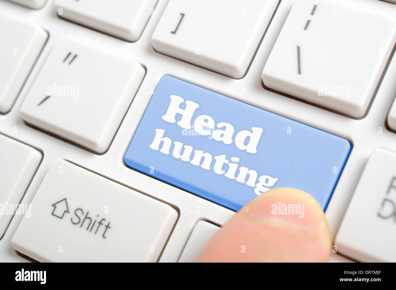 Pressing head hunting on keyboard Stock Photo - Alamy