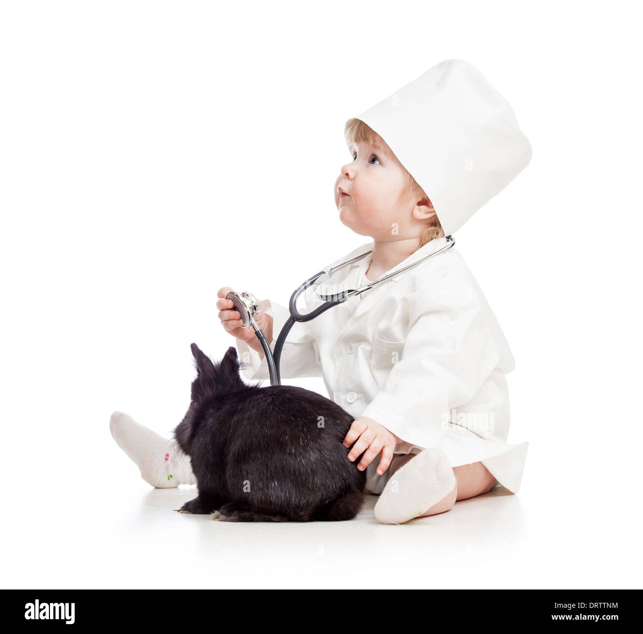 Baby playing doctor with pet bunny Stock Photo - Alamy