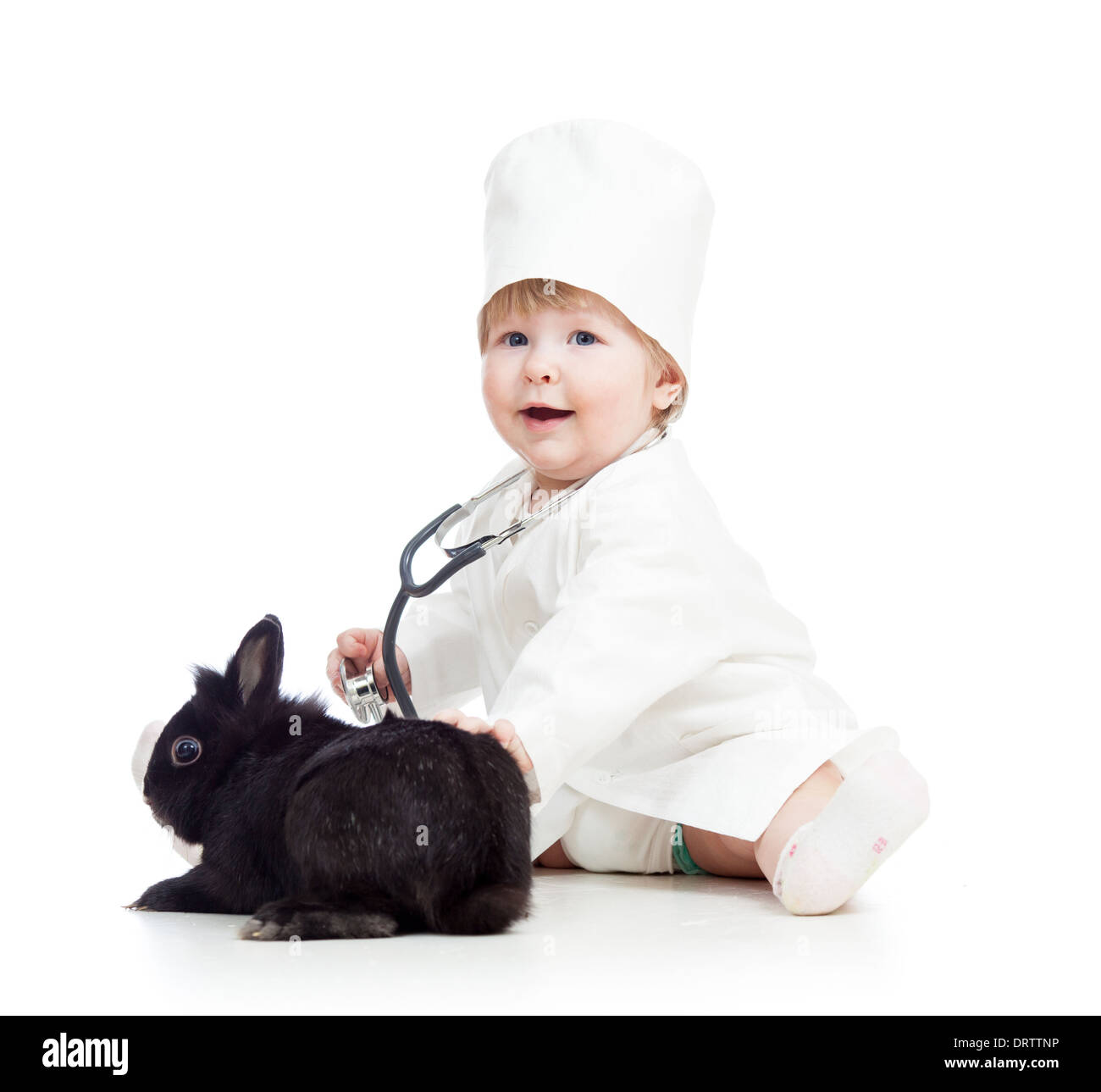 kid with clothes of doctor playing with pet bunny Stock Photo - Alamy