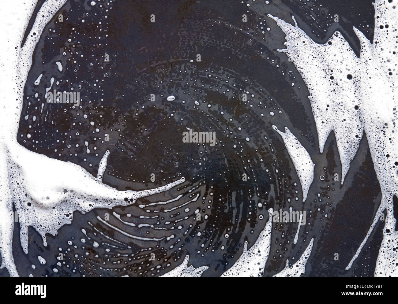 Circular traces of soapsuds on dark plate Stock Photo - Alamy