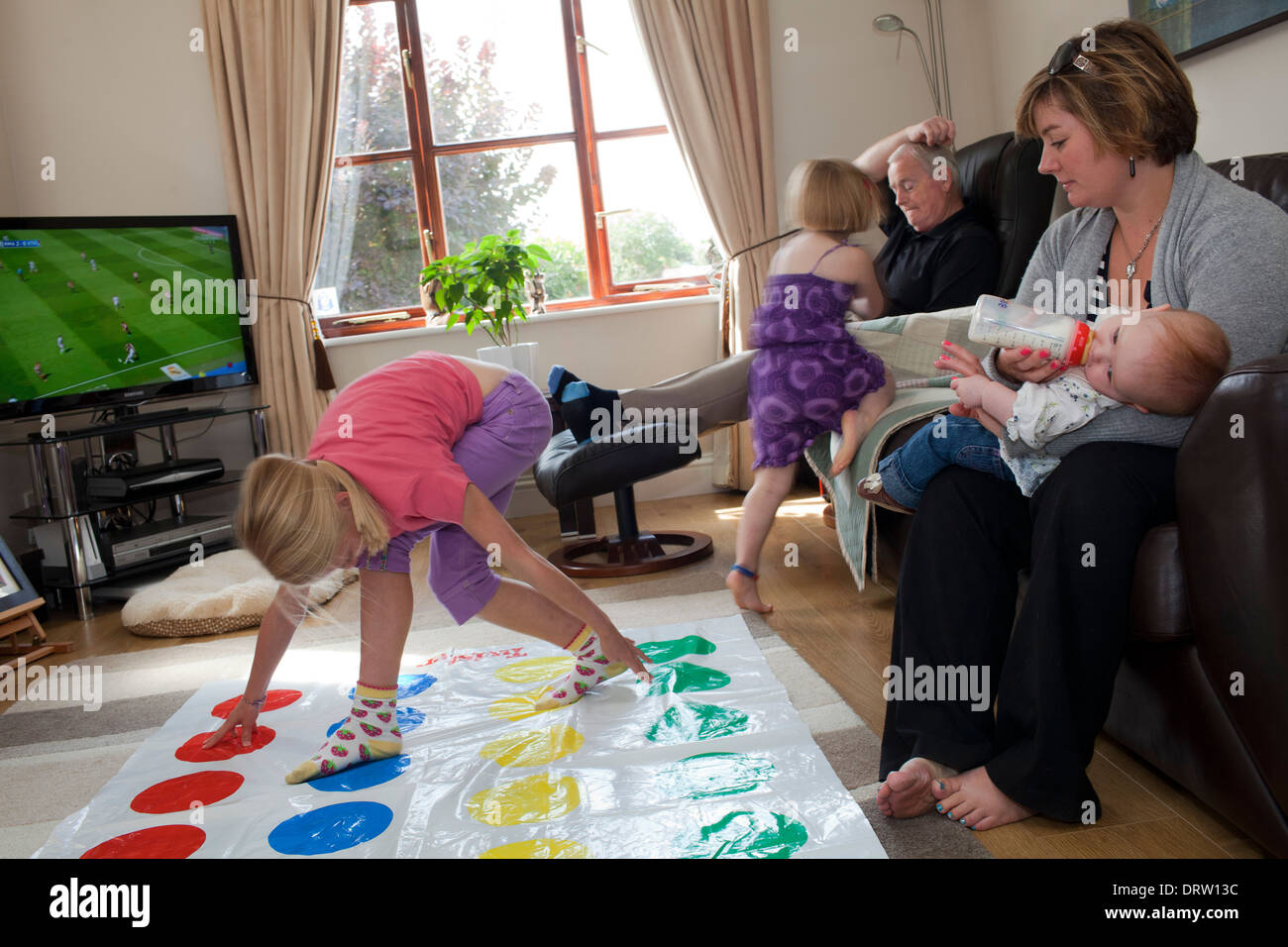Three generations family watching tv hi-res stock photography and ...