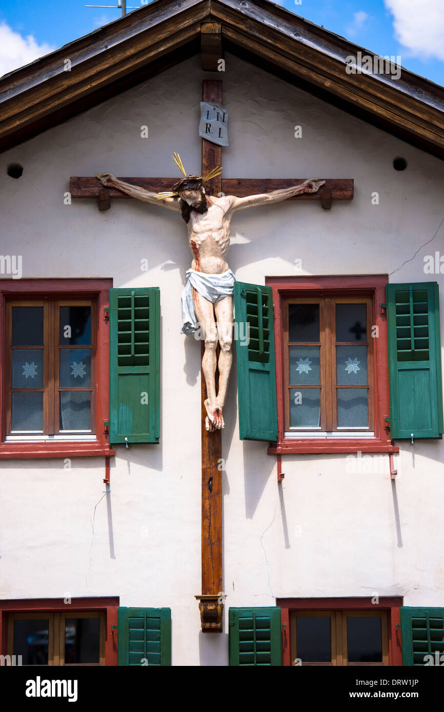 Christian crucifix on a traditional house in Mustair, Switzerlan Stock ...