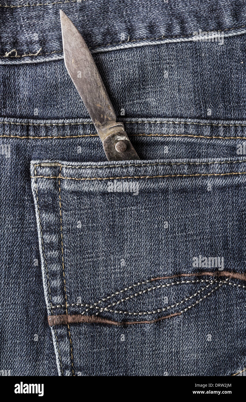 Old knife in the back pocket of jeans Stock Photo - Alamy