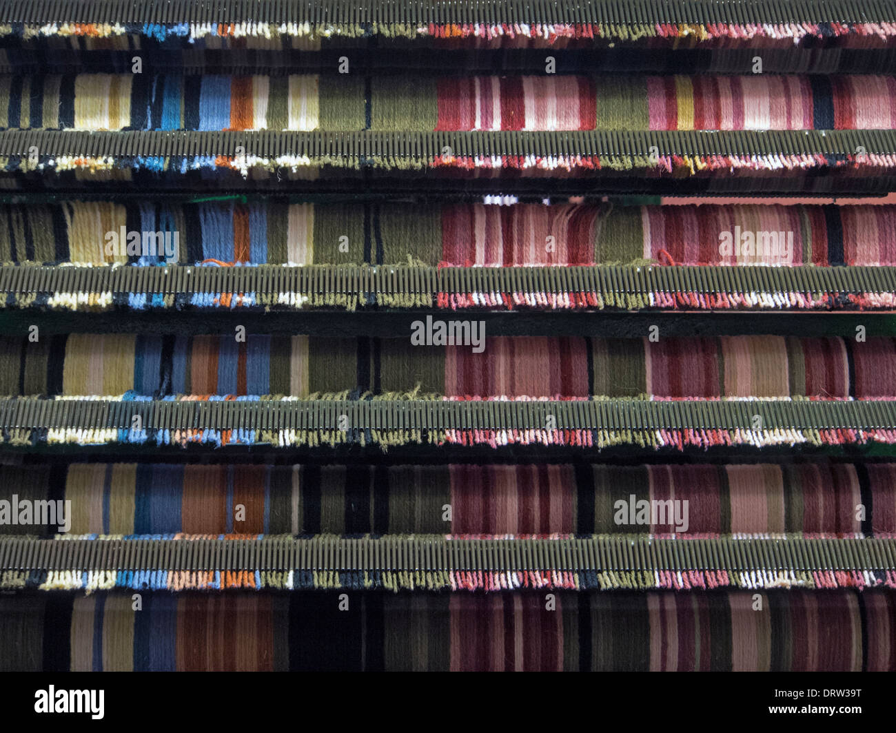 A close up of a machine which creates the tufts of wool for a ...