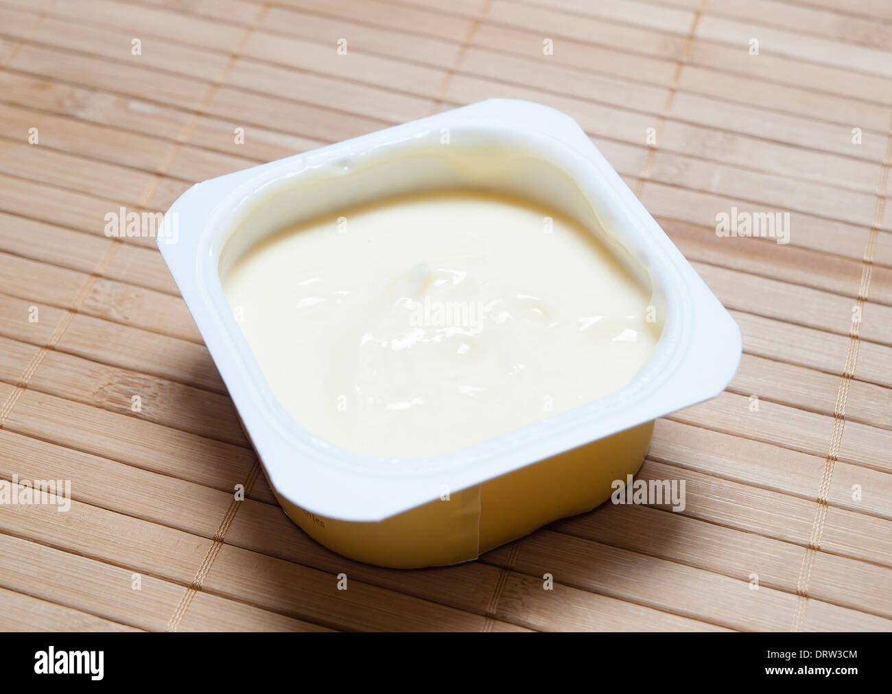 Vanilla custard in a plastic container on bamboo background Stock Photo ...