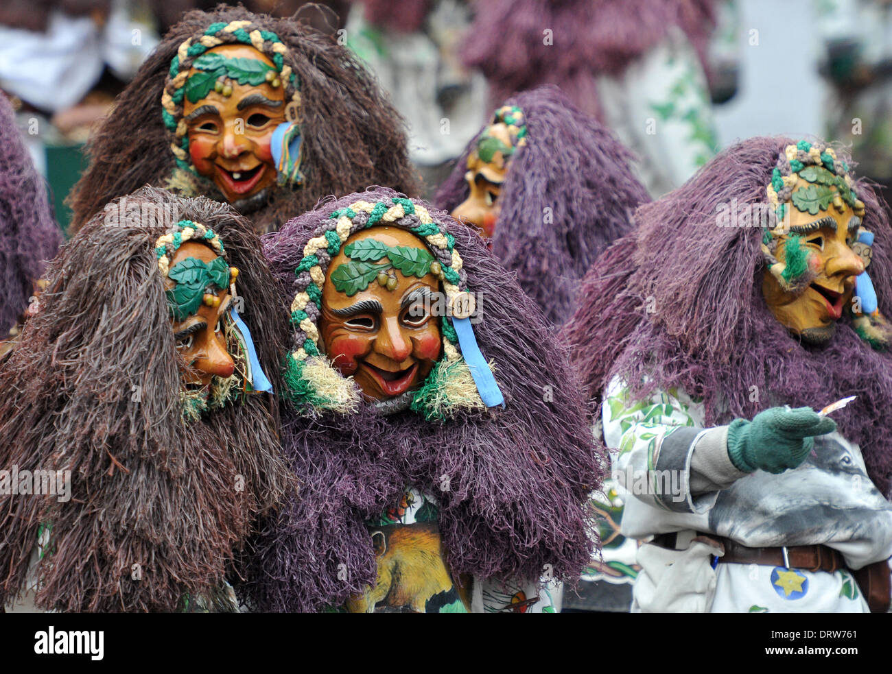 Masked carnival revellers march during a carnival procession through ...
