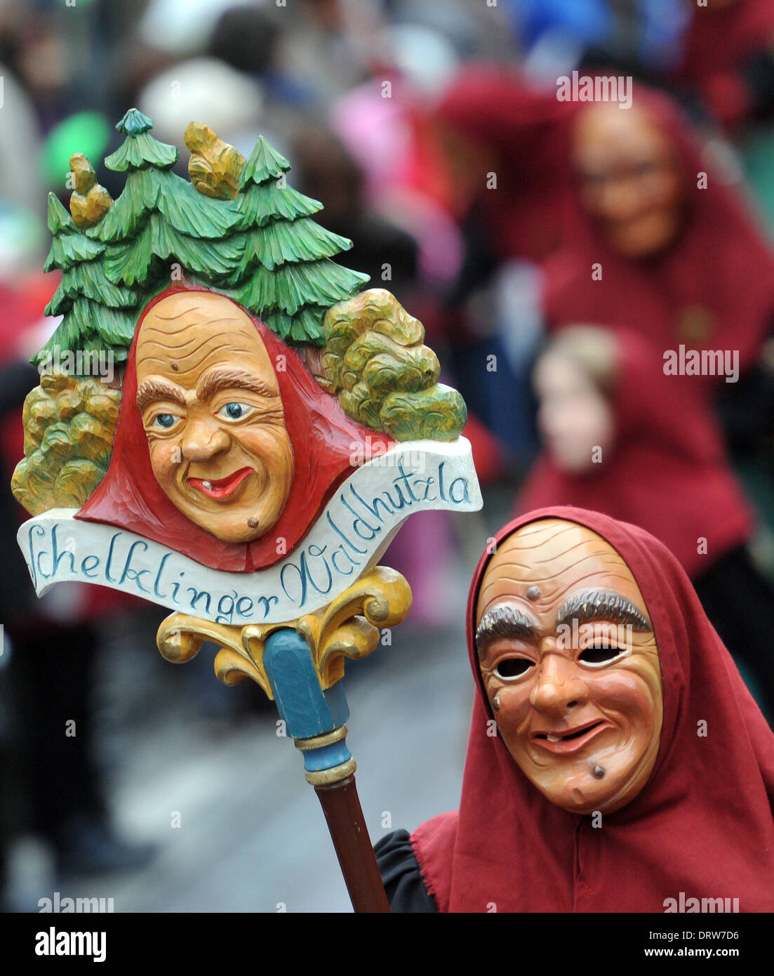 Masked carnival revellers march during a carnival procession through ...