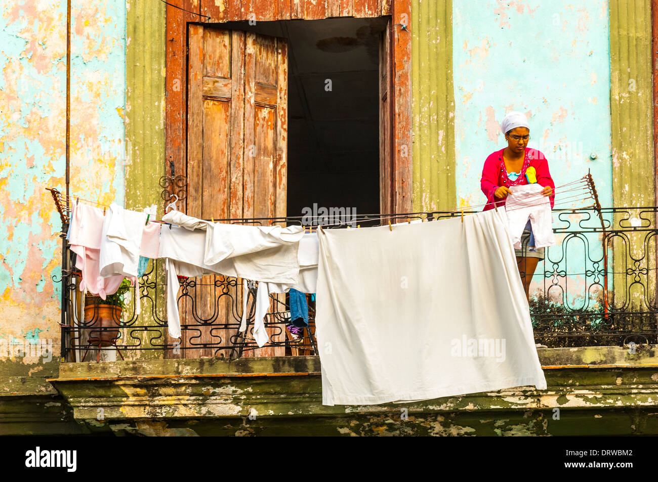 Woman hanging out washing on balcony hi-res stock photography and ...
