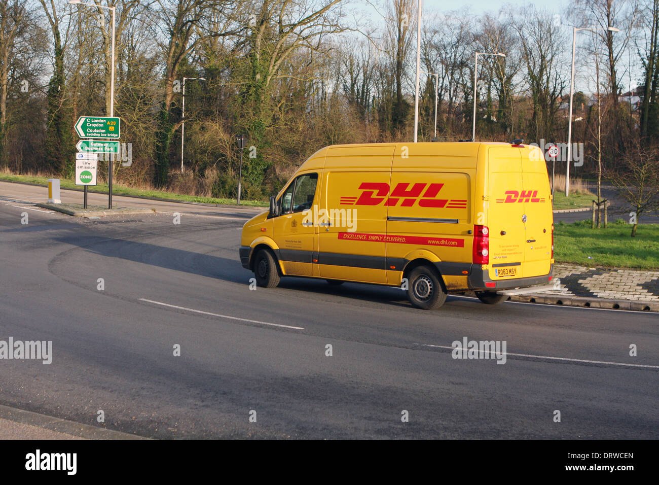 A DHL van traveling around a roundabout in Coulsdon, Surrey, England ...