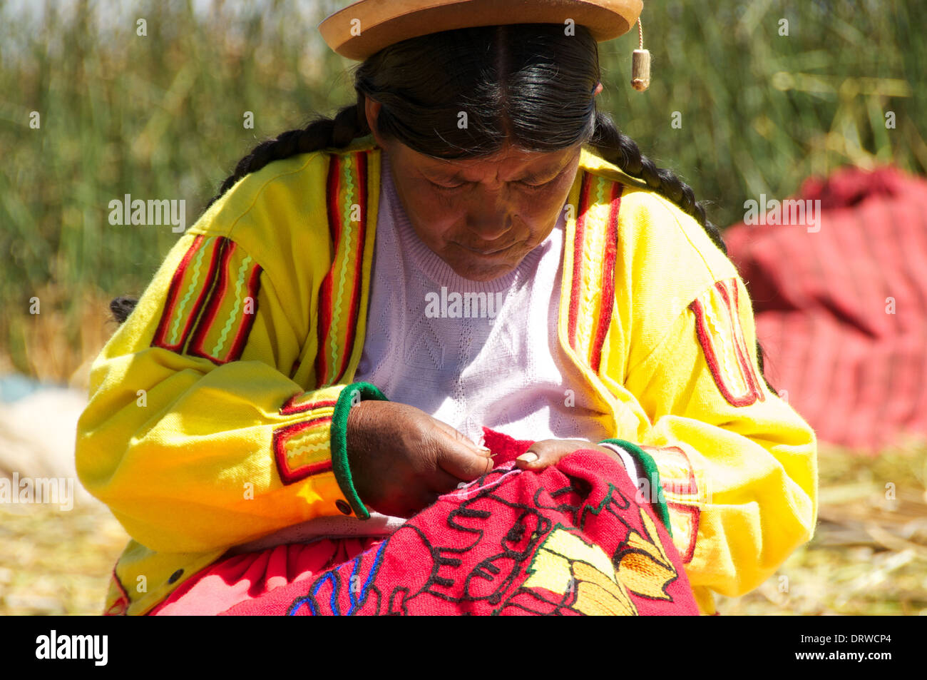 Inca woman in traditional dress embroidering colourful clothing on ...