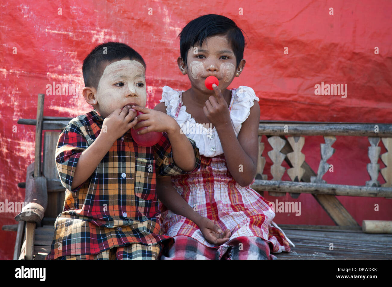 Two kids playing with balloons Bagan during the Ananda temple Festival ...