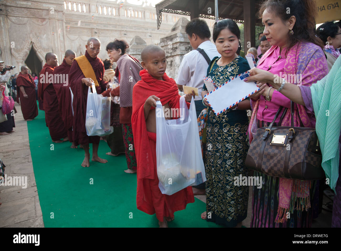 Monks receiving alms during The Ananda Festival Bagan, Myanmar (Burma ...