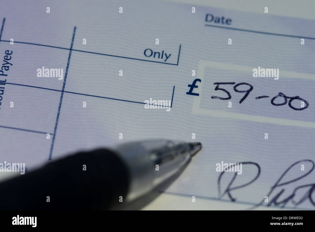 Signing a cheque uk hi-res stock photography and images - Alamy