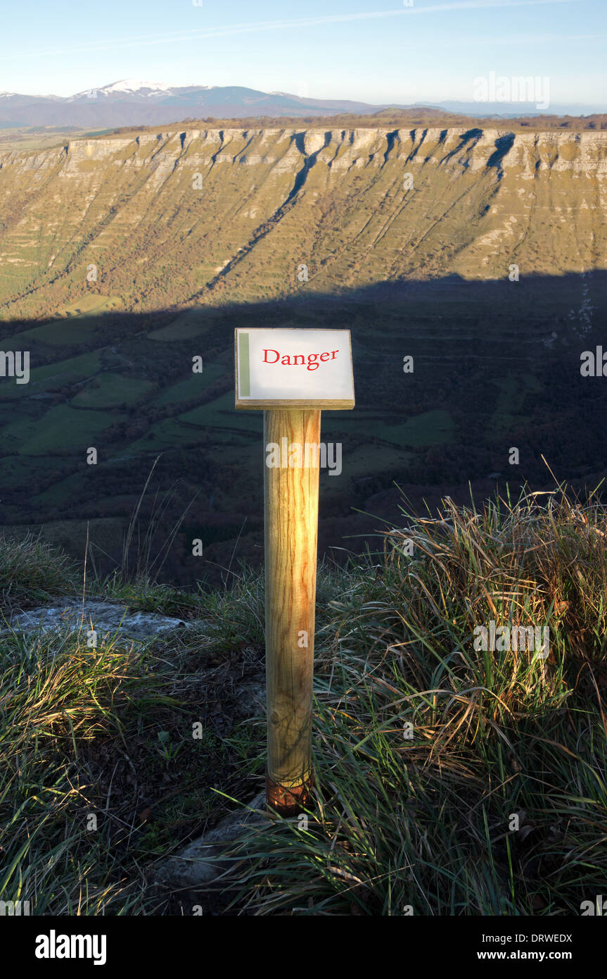 wooden post with danger sign on mountain cliff Stock Photo - Alamy