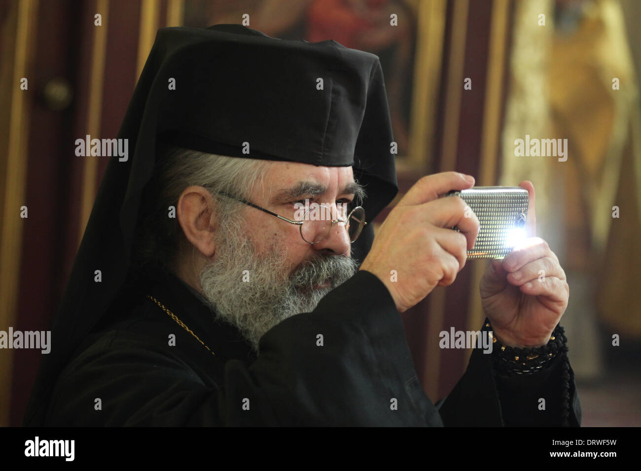 Hegumen Damian Urbasek takes a picture during the ceremony of his ...