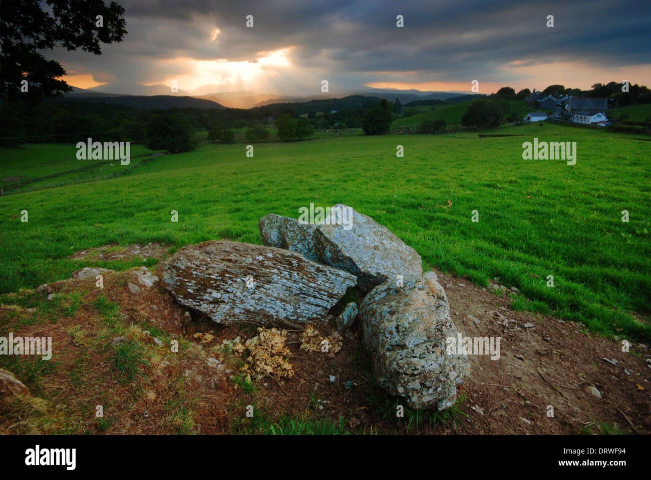 Rocks in North Wales, with sunset sky over the Snowdonia mountain range ...