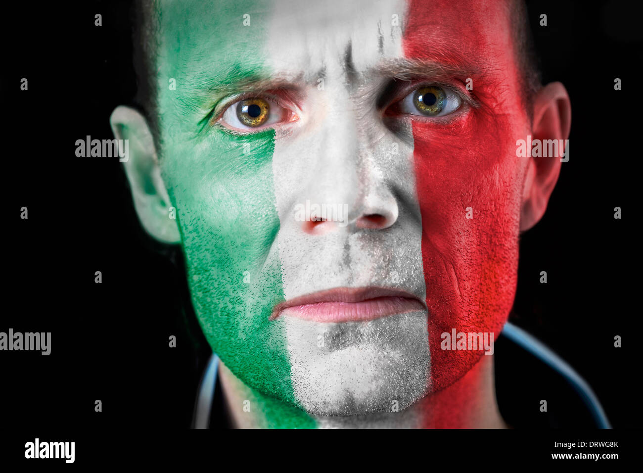 An intense stare from a football fan with their face painted with the ...