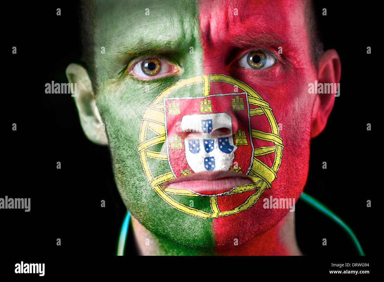 An intense stare from a football fan with their face painted with the ...