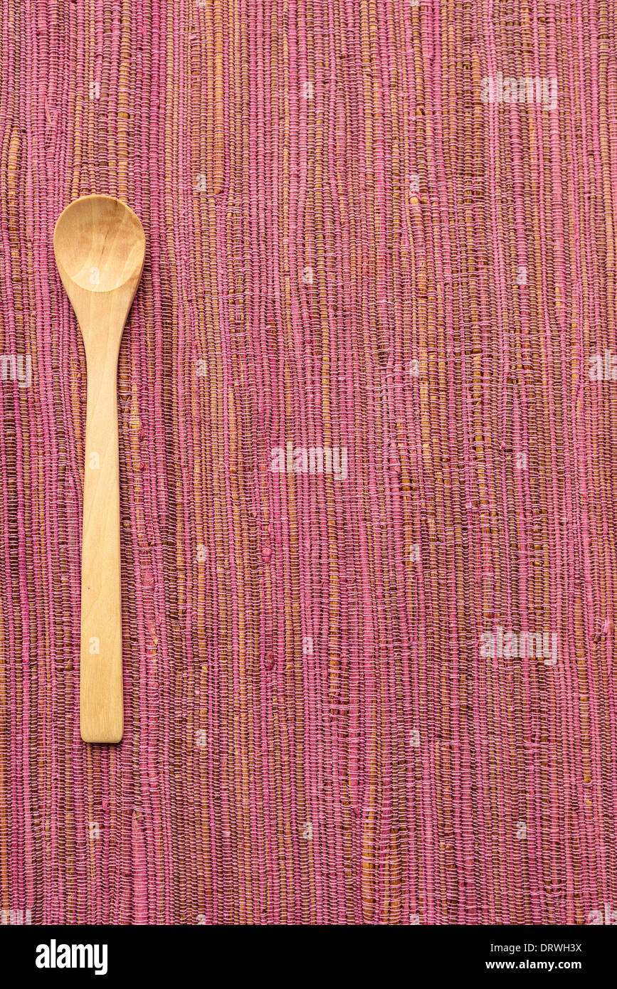 wooden spoon on a colorful violet textile Stock Photo - Alamy
