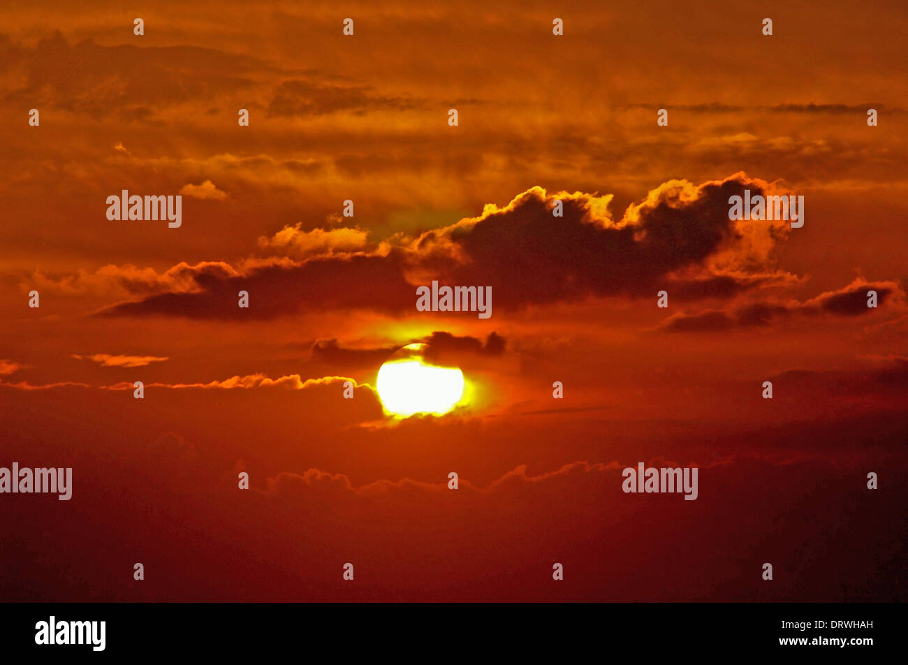 Abstract image of a sunset partly obscured by clouds Stock Photo - Alamy