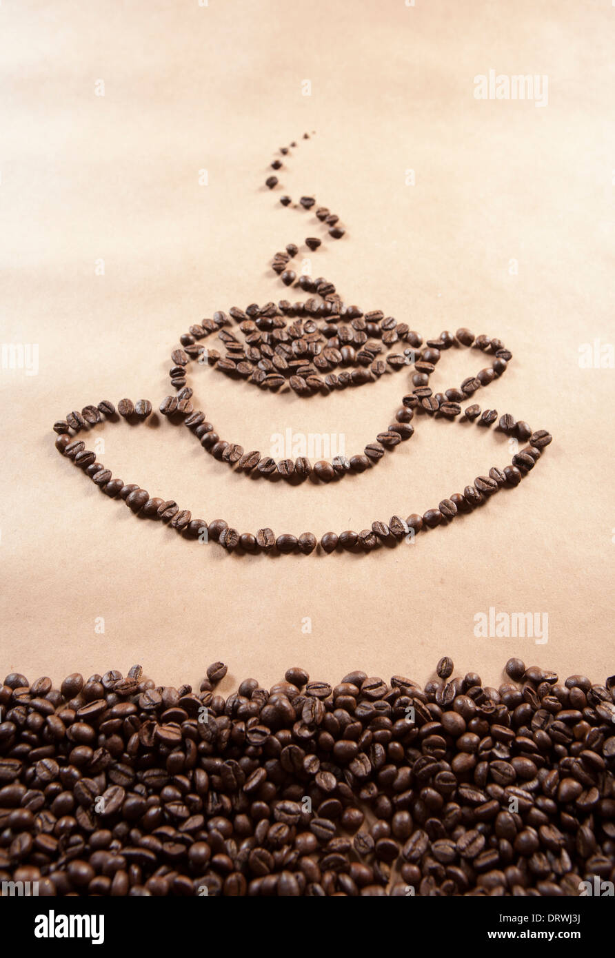 Coffee cup made by roasted beans. On the sand background. Coffea ...