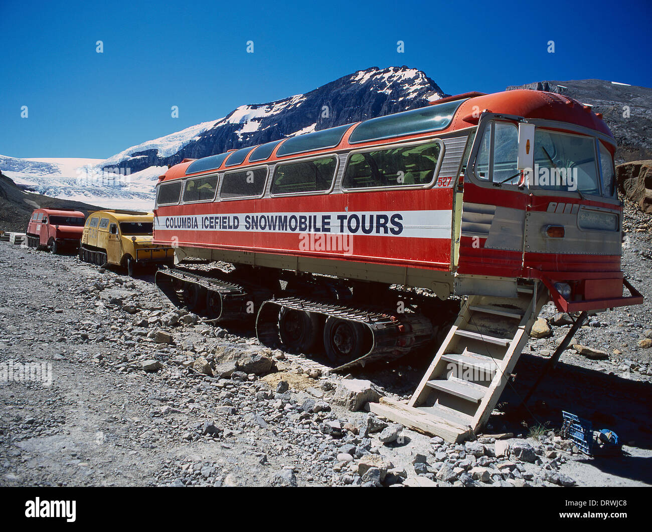 Old snowmobiles and snowcoach at the Athabasca Glacier, Coulmbian ...
