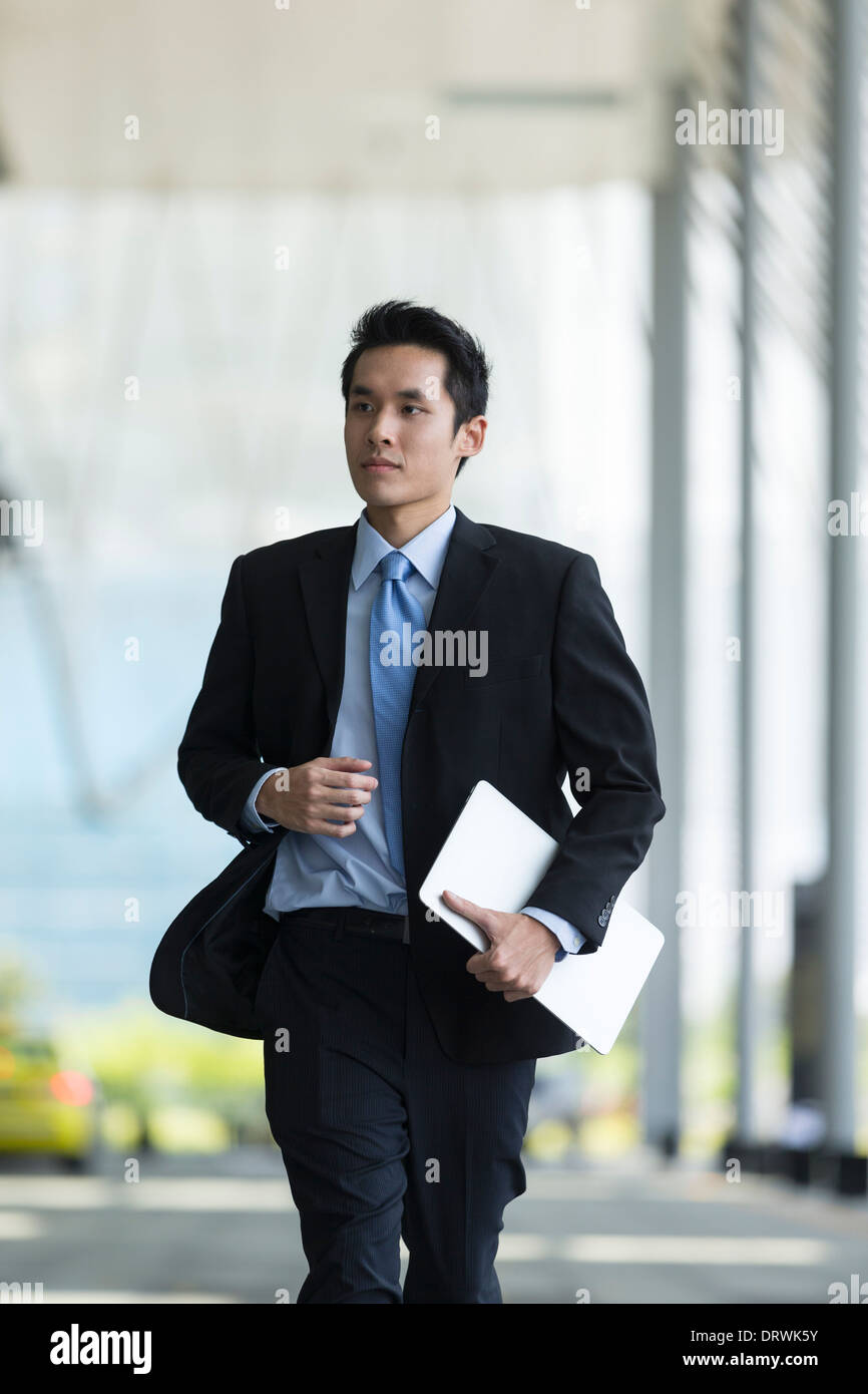 Asian businessman running holding hi-res stock photography and images ...