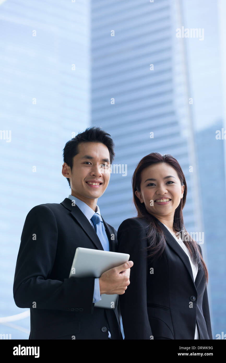 Portrait of Chinese business man and woman in a modern urban setting ...