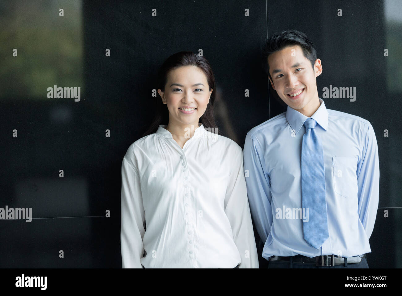Portrait of Chinese business man and woman in a modern urban setting ...