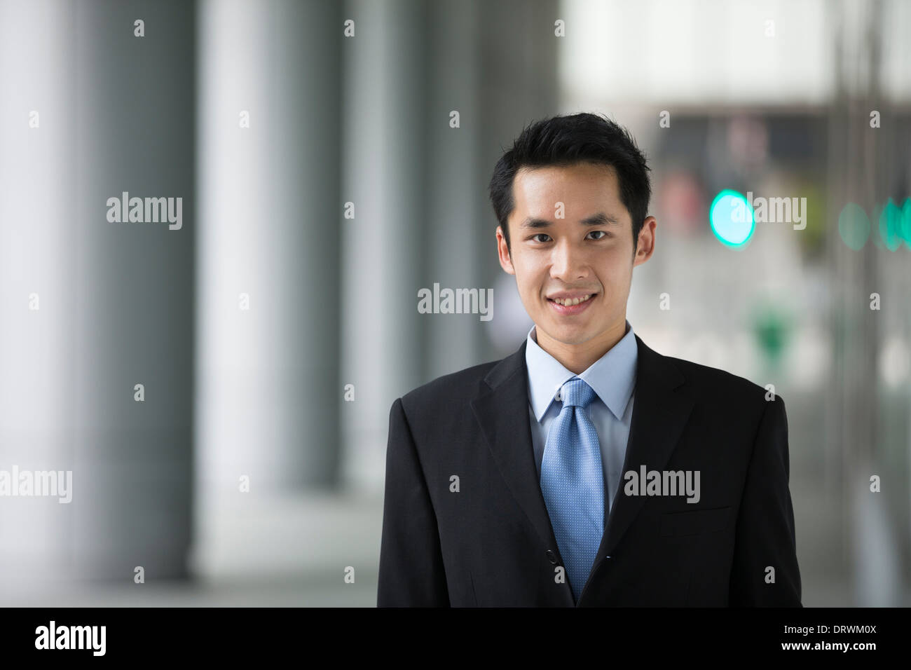 Chinese business man in modern Asian city Stock Photo - Alamy