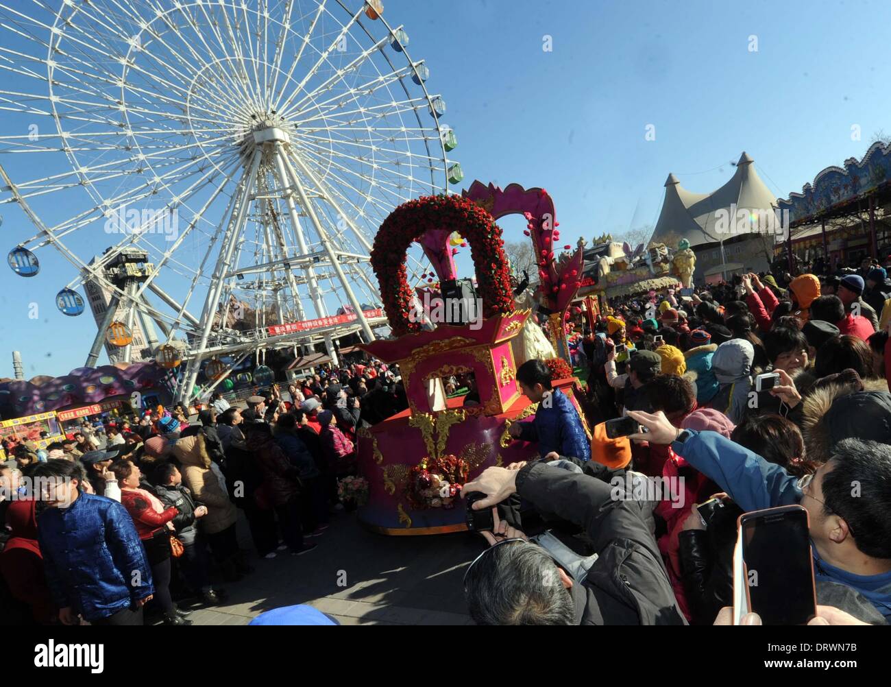 Beijing, China. 3rd Feb, 2014. Tourists watch a float parade during the ...