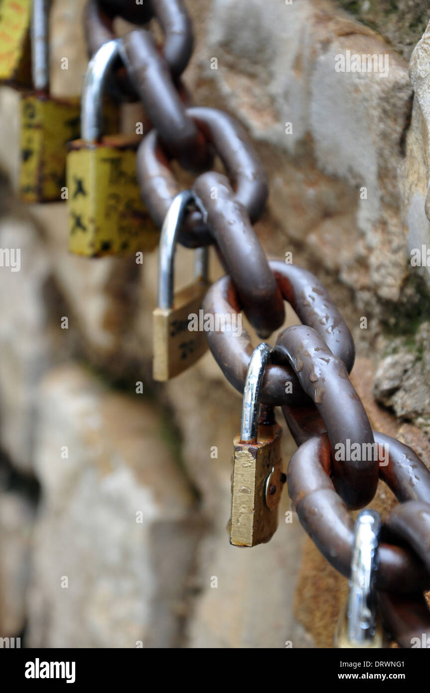 Padlocks attached to an iron chain by couples as a symbol of engagement ...