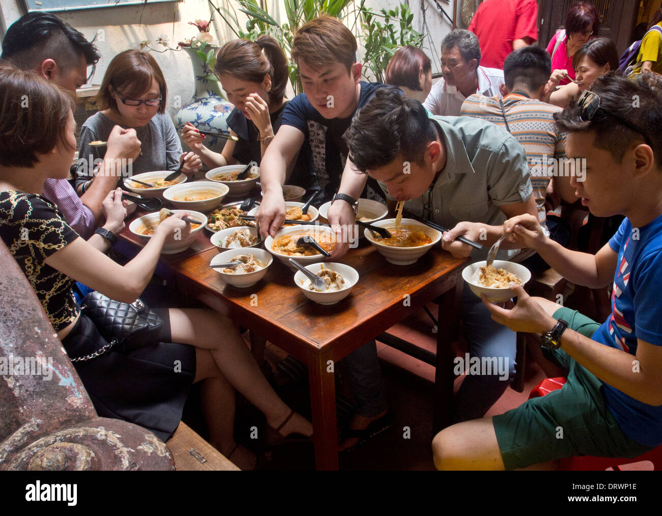 Tourists eat at traditional chinese shophouse restaurant in Malacca, a ...
