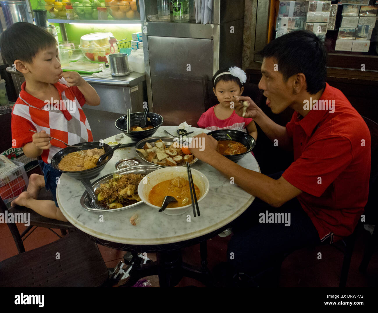 Tourists eat at traditional chinese shophouse restaurant in Malacca, a ...