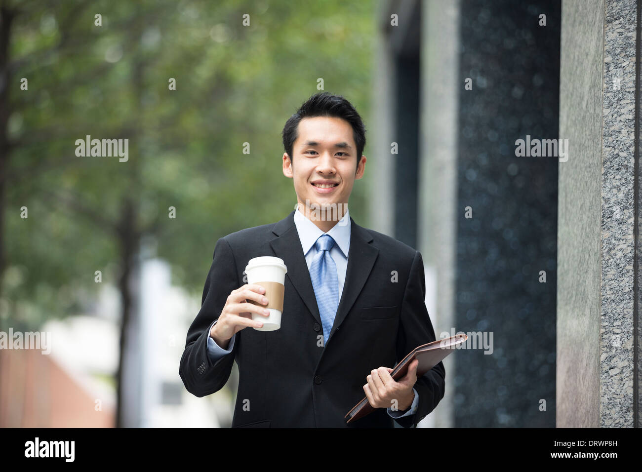 Chinese business man in modern Asian city Stock Photo - Alamy