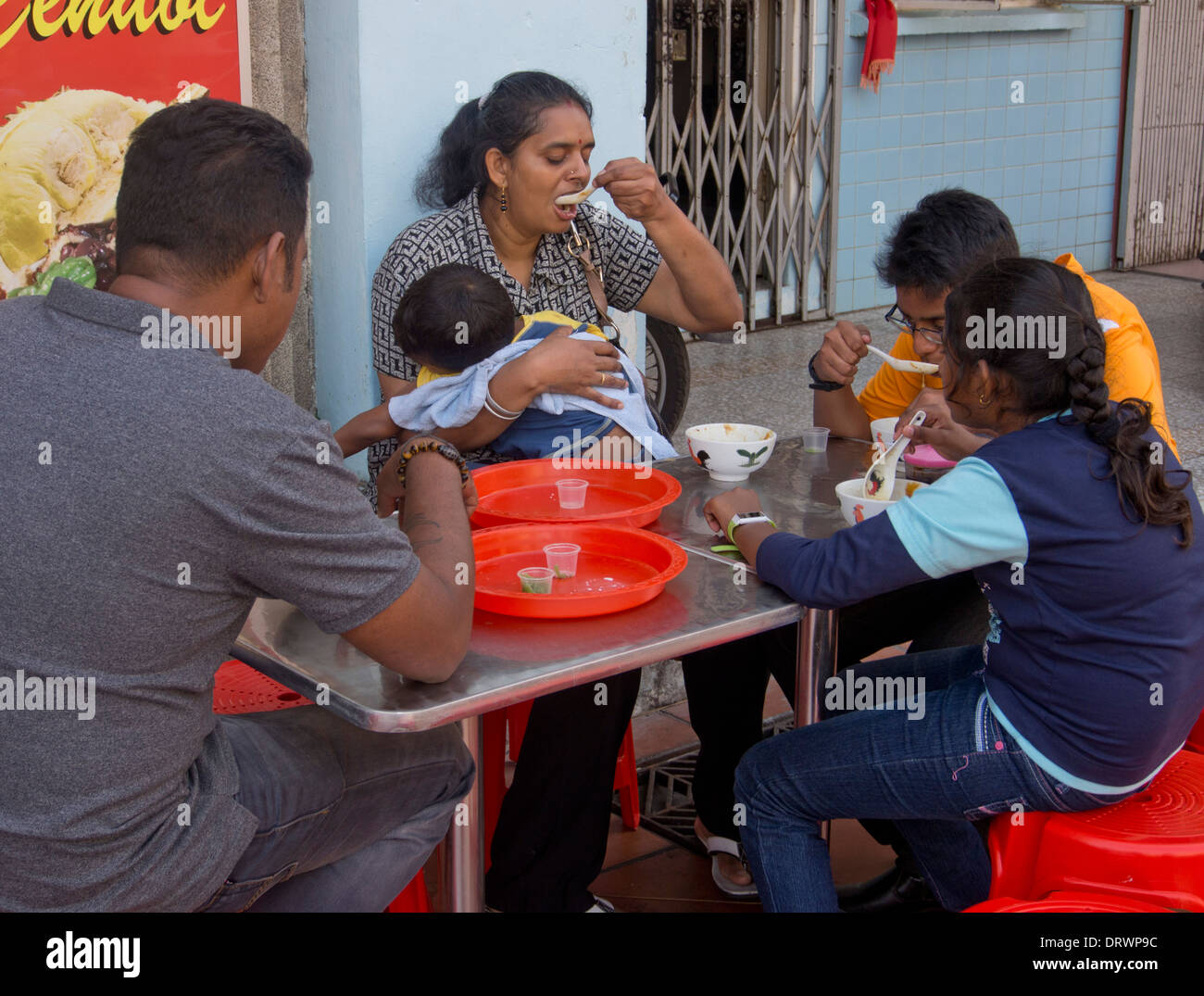 Family eating at street food stallMalacca, a UNESCO World Heritage Site ...