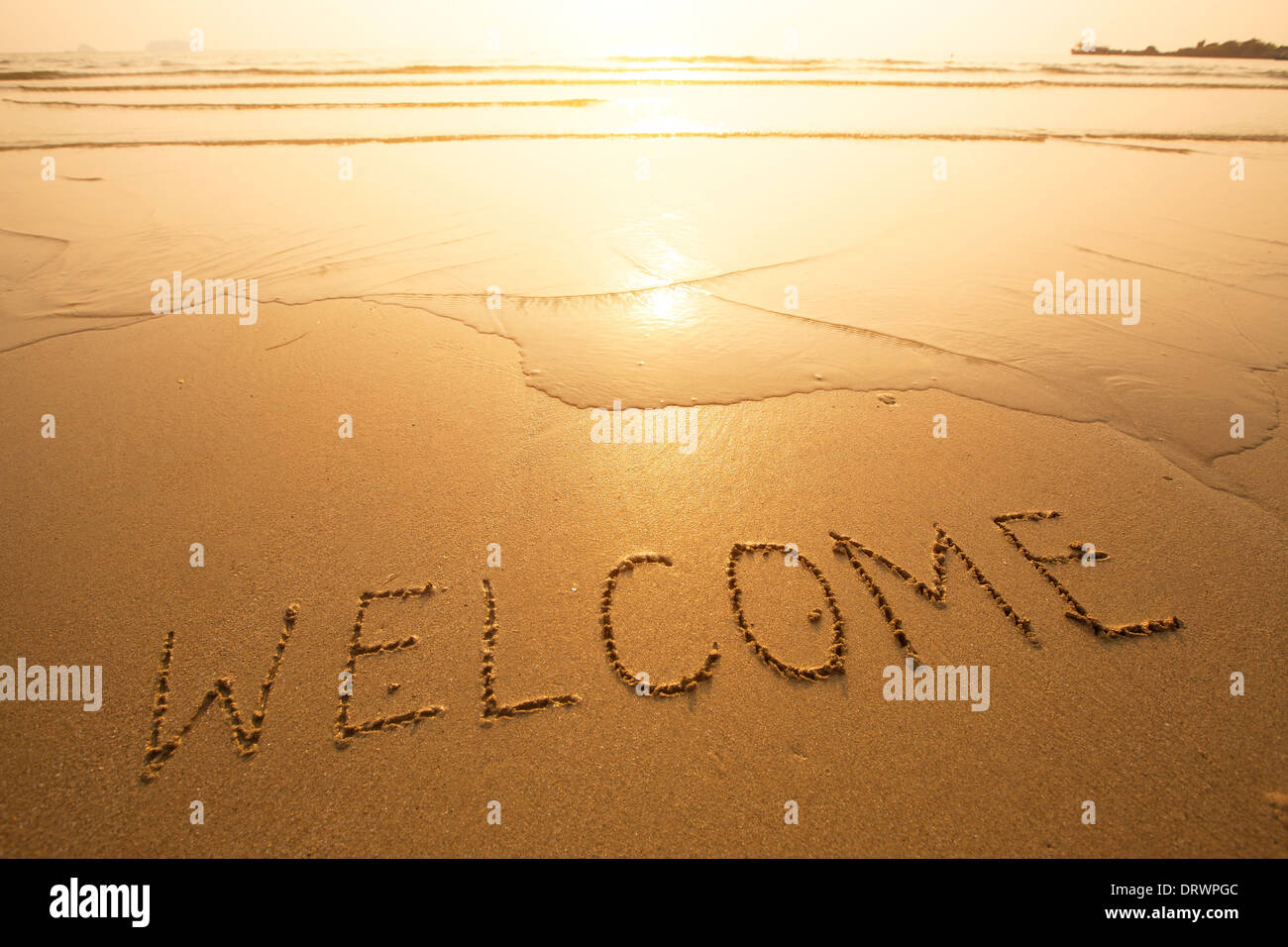 Welcome, texture on the beach sand Stock Photo - Alamy