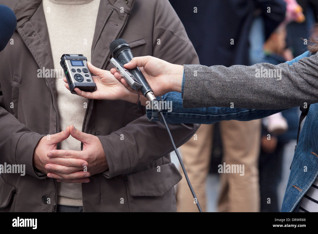 A journalist is making a interview with a microphone Stock Photo - Alamy