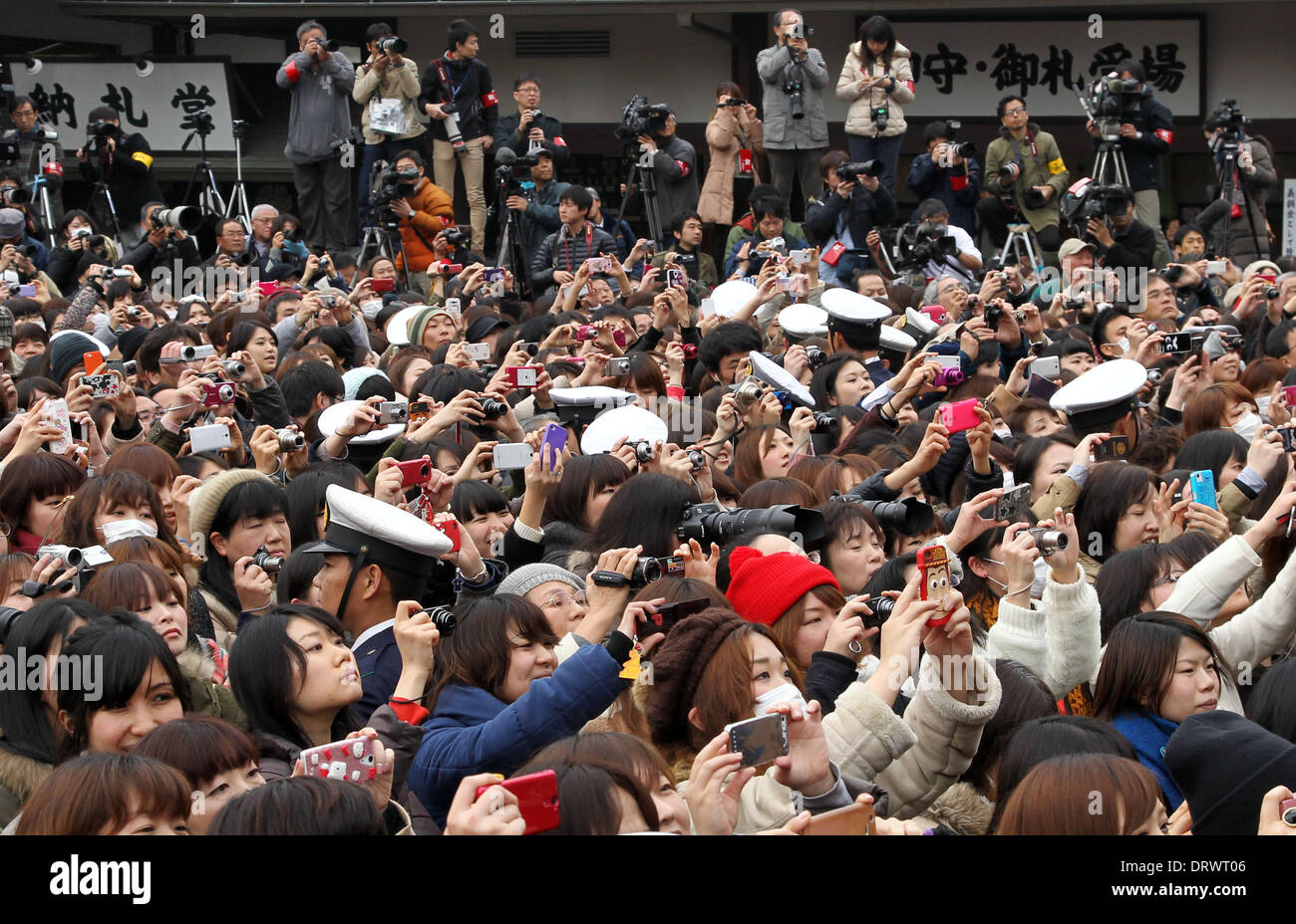 Tokyo, Japan. 3rd Feb, 2014. Visitors reach out for the beans thrown by ...