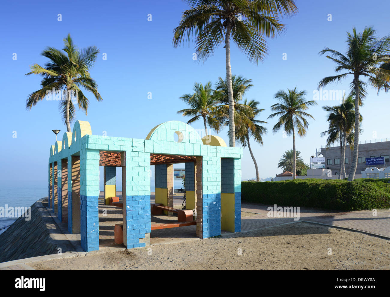 MUSCAT OMAN - the colourful buildings under the palm trees on the ...