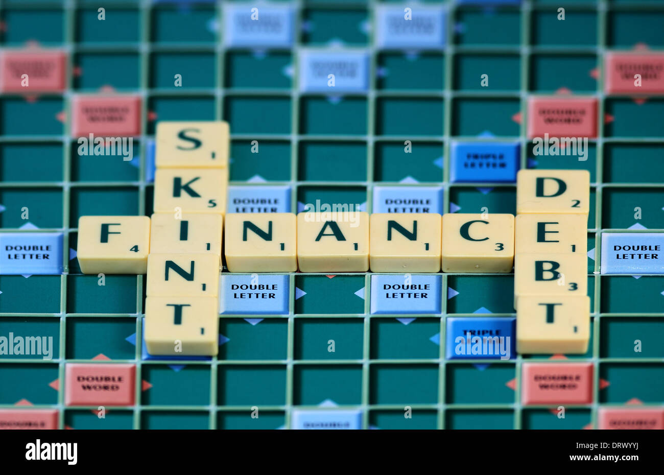 scrabble board game tiles finance Stock Photo - Alamy