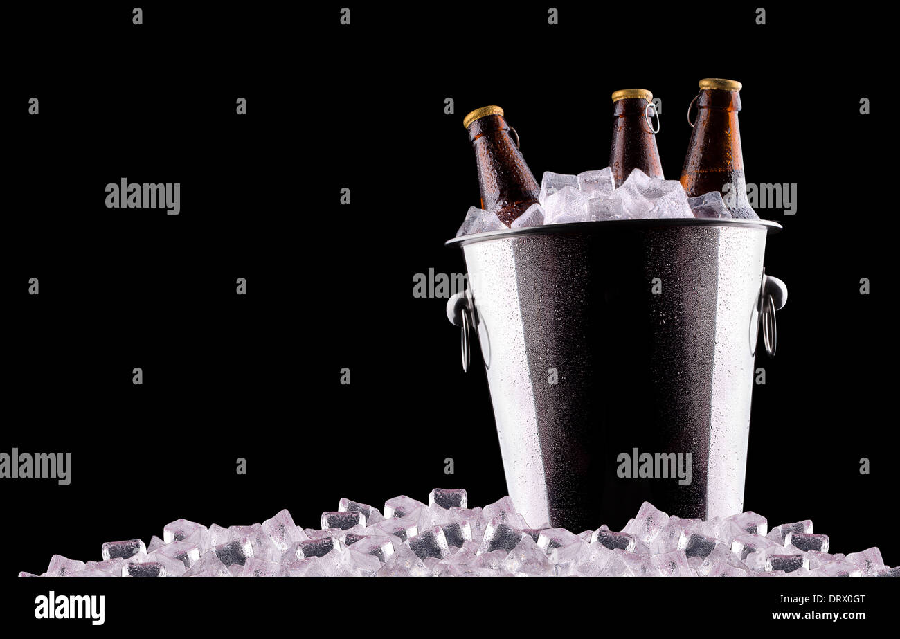Beer bottles in ice bucket isolated on black Stock Photo - Alamy