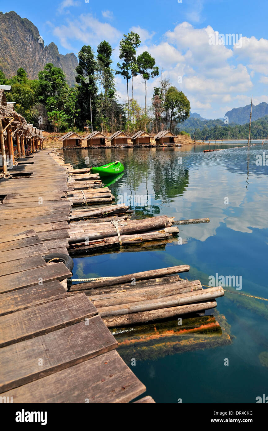 Tropical lakeside hut and wooden boat in ratchaprapa Dam,Khao Sok ...