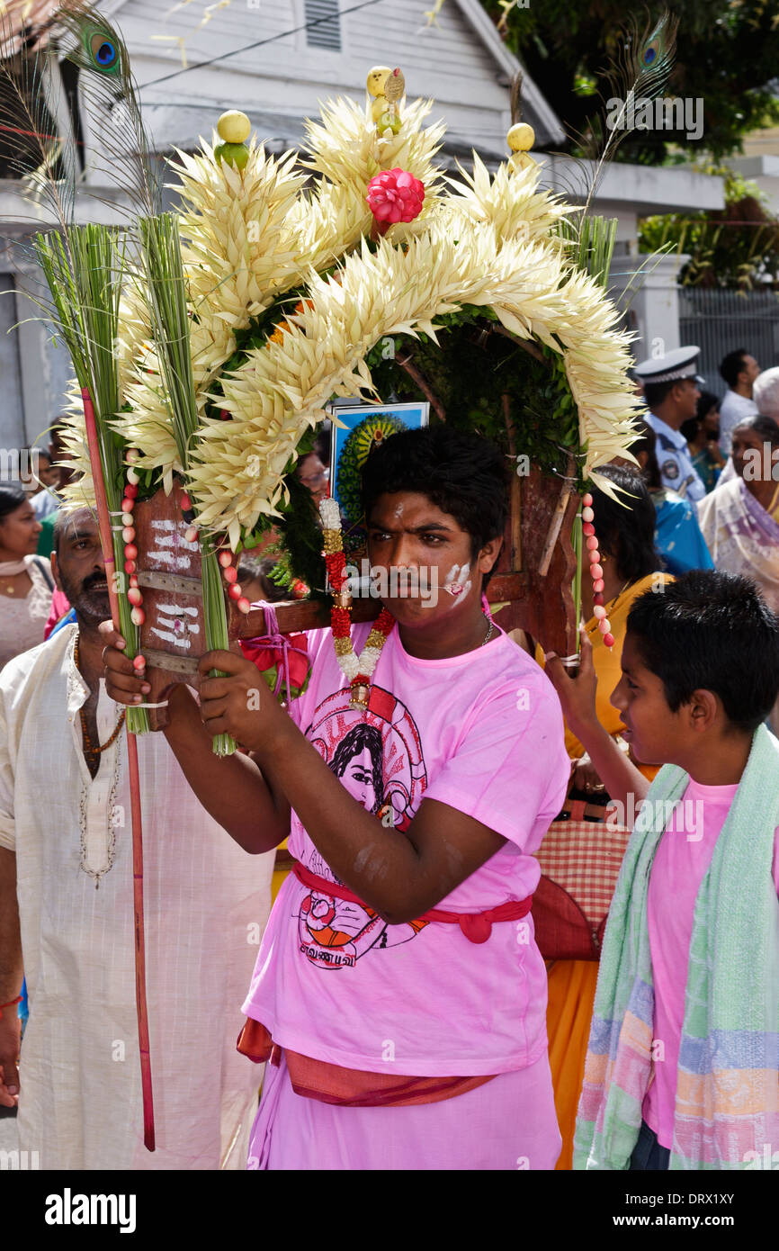 Devotee of the Lord Muruga carrying the Cavadee during the Thaipoosam ...
