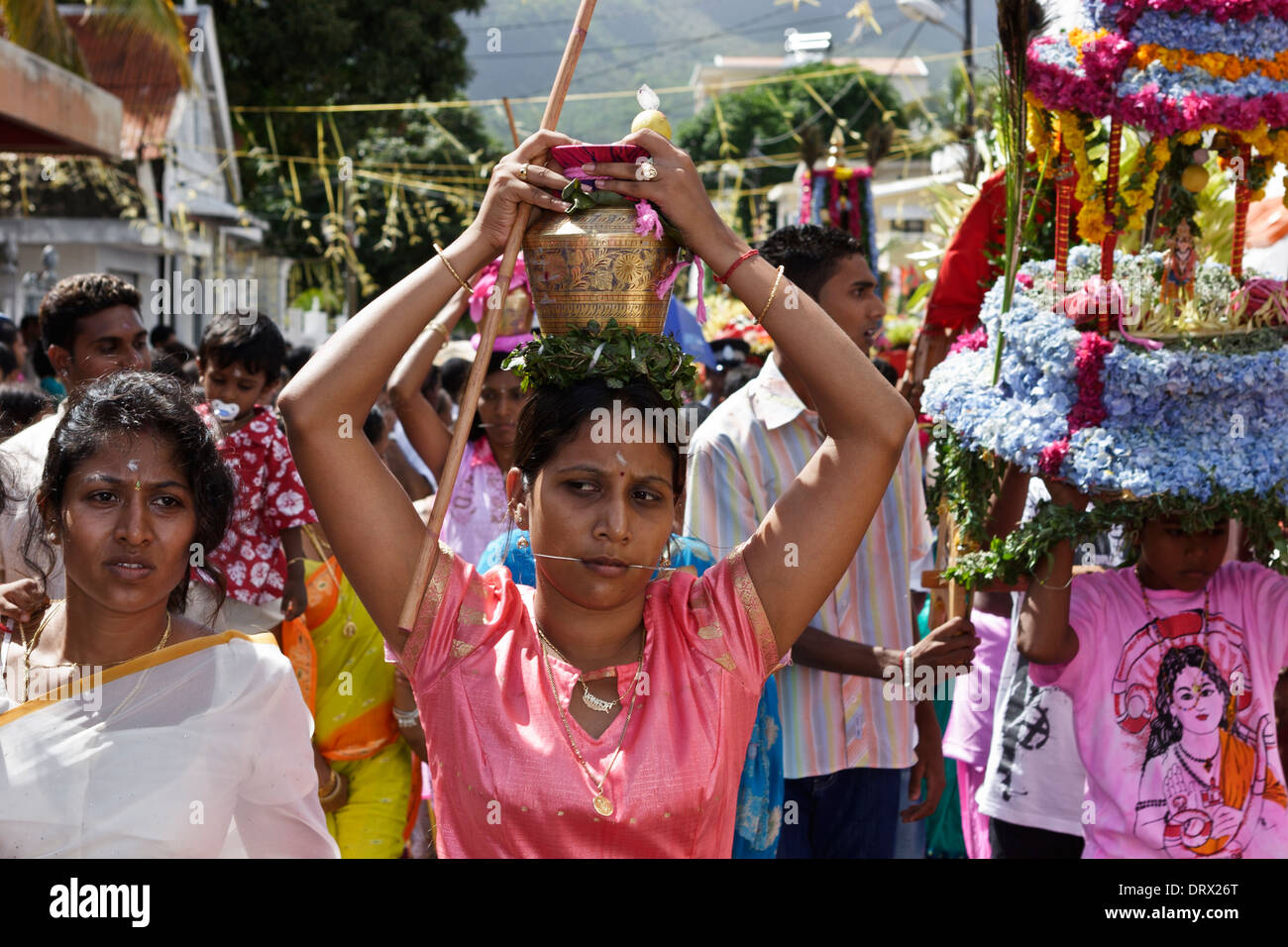 A female devotee of the Lord Muruga carrying a brass pot containing ...