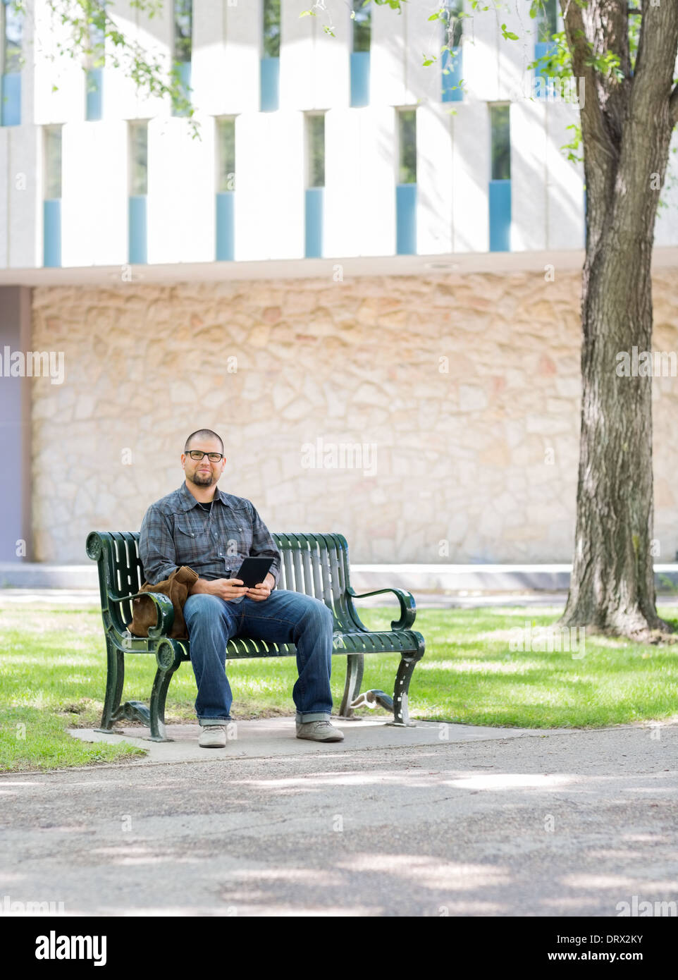Student Sitting On Bench At University Campus Stock Photo - Alamy