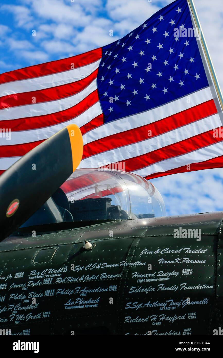 An American flag flies over a WW2 B24 Liberator bomber plane Stock ...