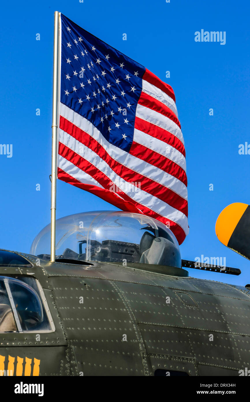 An American flag flies over a WW2 B24 Liberator bomber plane Stock ...