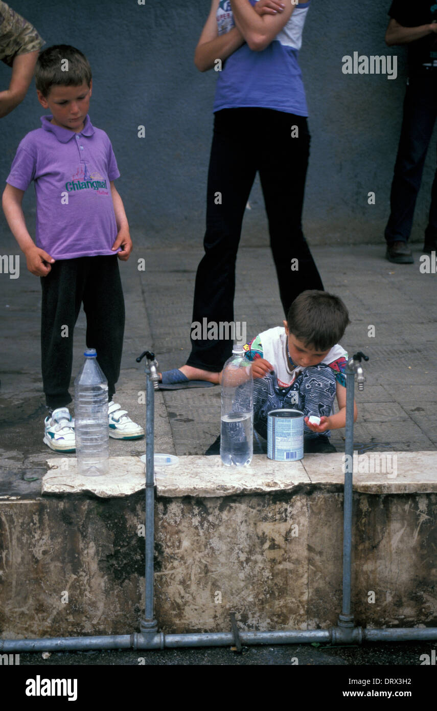 Child collecting water at refugee camp in Tirana, Albania for Kosovar ...