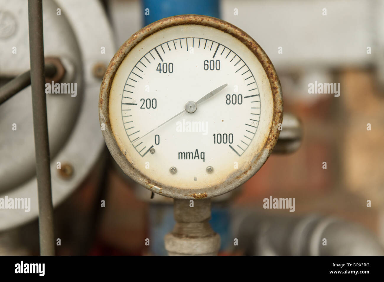Rusty Pressure Gauge connected to pipes with brick wall behind Stock ...